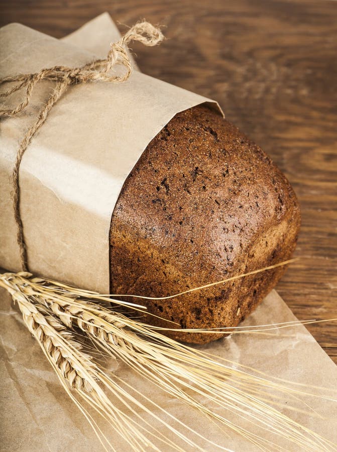 Black Bread in a Paper Packing with Ears of Wheat Stock Image - Image ...