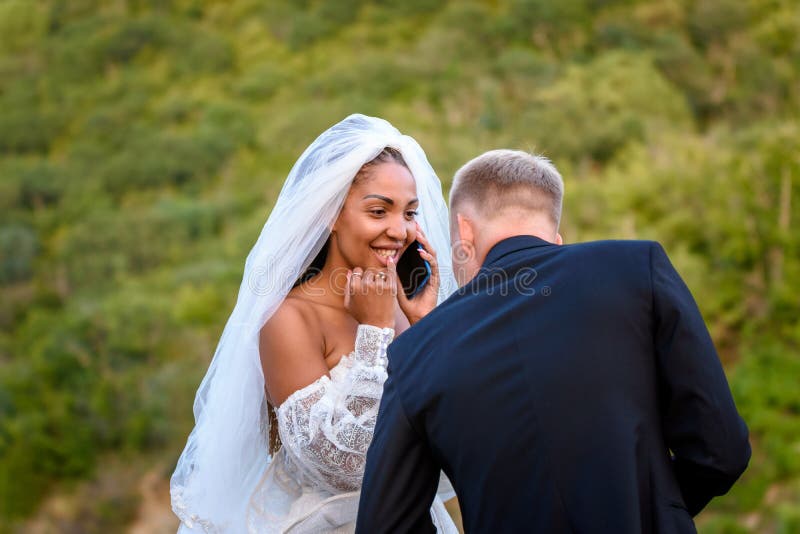 A Black Bride Accepts Congratulations on the Phone and Looks Happily at ...