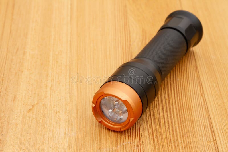 LED Flashlight on Wood Table Stock Photo - Image of electricity, lamp ...