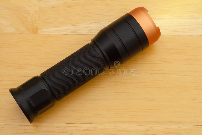 LED Flashlight on Wood Table Stock Image - Image of light, lamp: 267141413