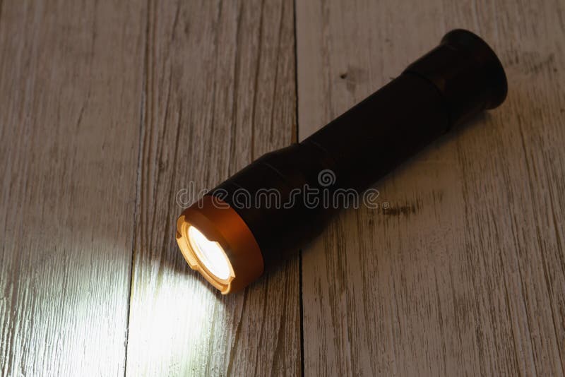 LED Flashlight on Wood Table Stock Image - Image of flashlight ...