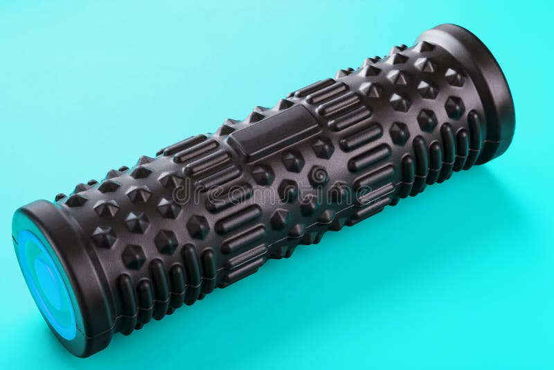 Black Bumpy Foam Massage Roller, Body Roller on Blue Background. F ...