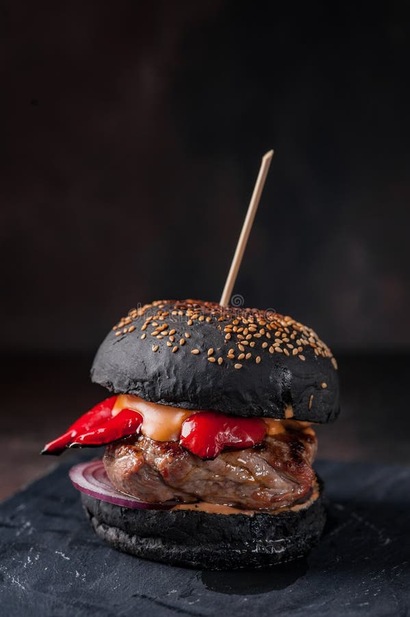 Black Burger with Cheese. Cheeseburger on Dark Background Stock Photo ...