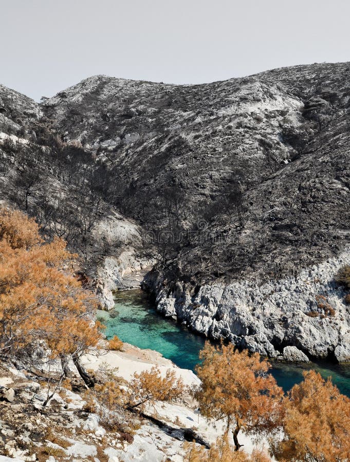 Black Burnt Land and Blue Bay Stock Image - Image of fire, burned: 22280261