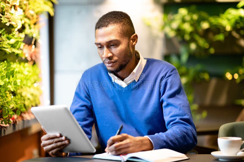 Black Business Guy Taking Notes in Notebook Holding Tablet Stock Image ...