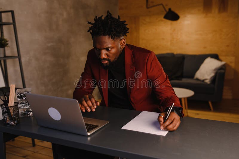 Black Business Man Working on Laptop and Taking Notes Stock Photo ...