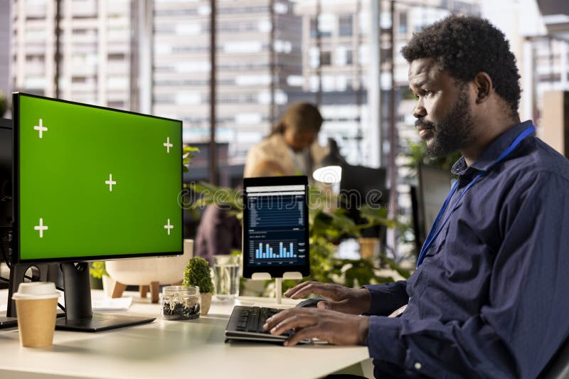 Black Businessman at Office Desk Works on daily Tasks Next To Green ...