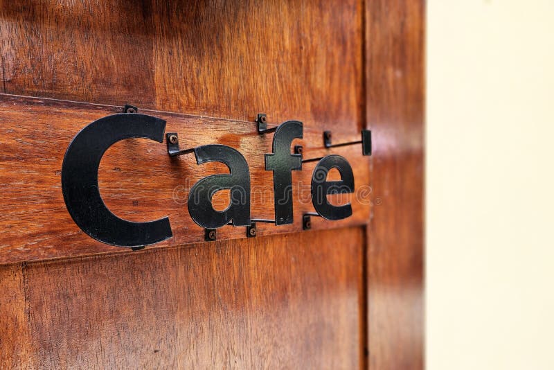 Black Cafe Sign on Wooden Door. Stock Photo - Image of modern, street ...