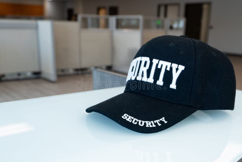 Black Cap with Embroidered Words "security" on an Office Front Desk ...