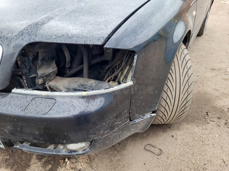 A Black Car with a Broken Headlight is Parked in the Yard. Stock Image ...