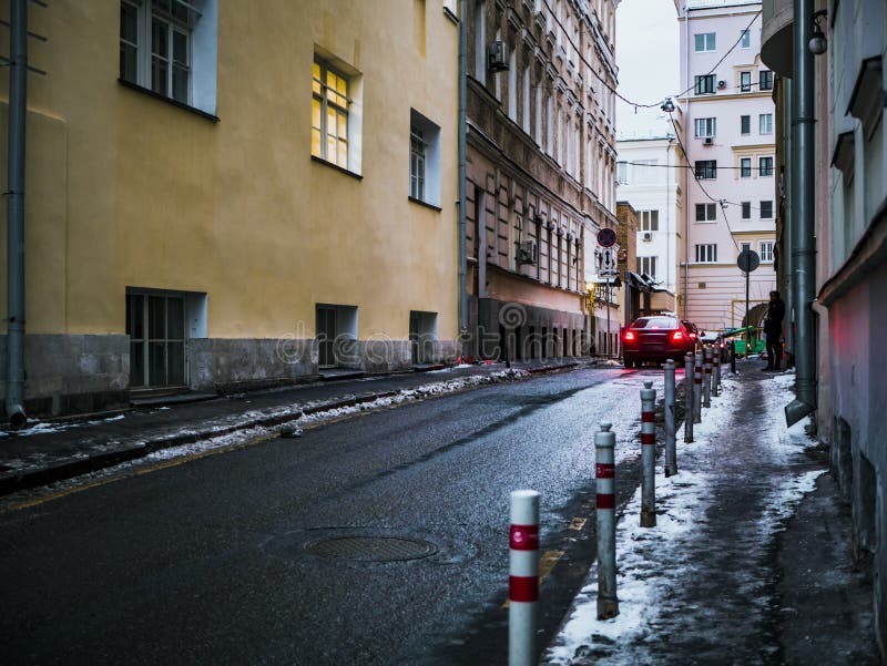 Black Car Crossing Asphalt Road between Buildings Stock Photo - Image ...