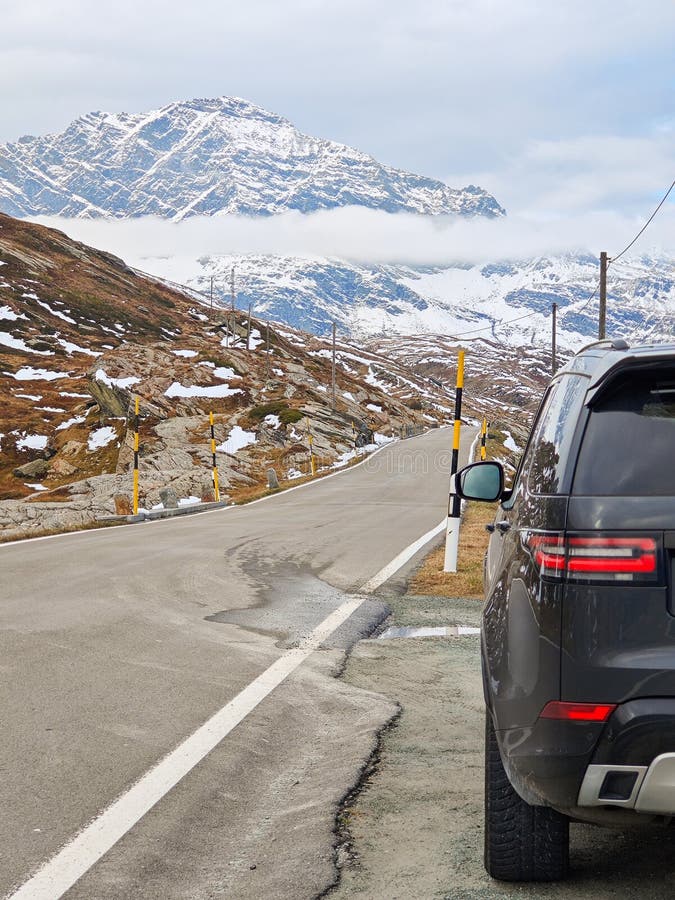 A Black Car is Parked on the Side of a Road Swiss Alps Stock Photo ...