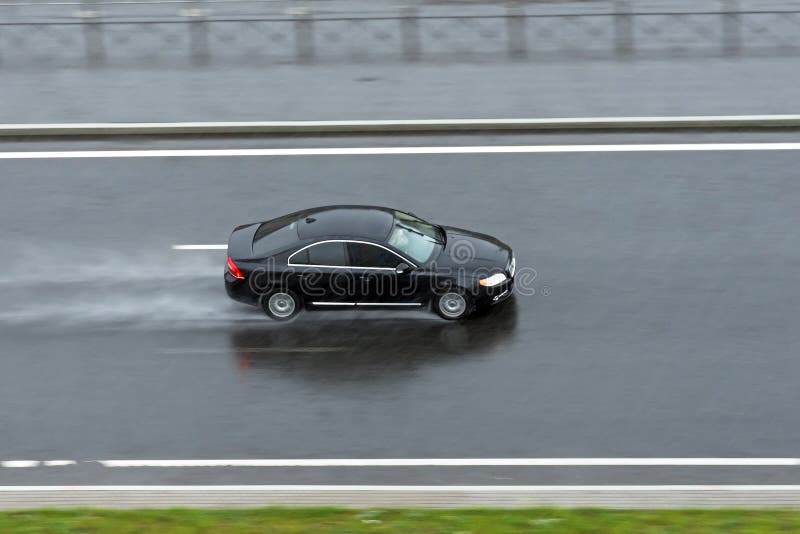 Black Car Rides in the Rain on the Highway. Stock Image - Image of ...
