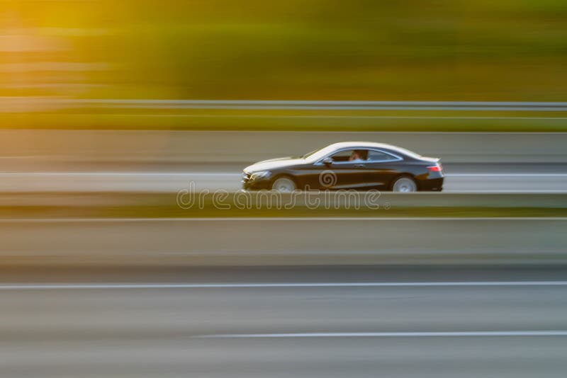 Black Car Speeding in Motion on a Highway on a Sunny Day Stock Image ...