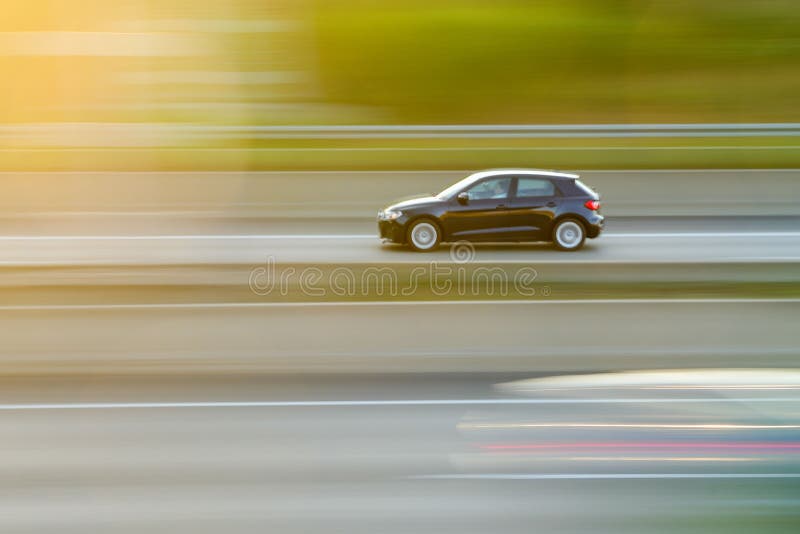 Black Car Speeding in Motion on a Highway on a Sunny Day Stock Photo ...