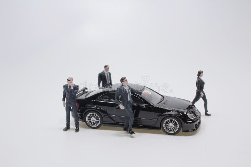 A Black Car with the Team of Mini Security Guard Stock Photo - Image of ...