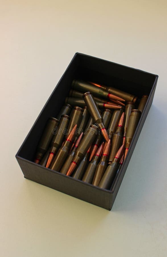 Black Case with Scattered Bullets on a White Surface Vertical Photo ...