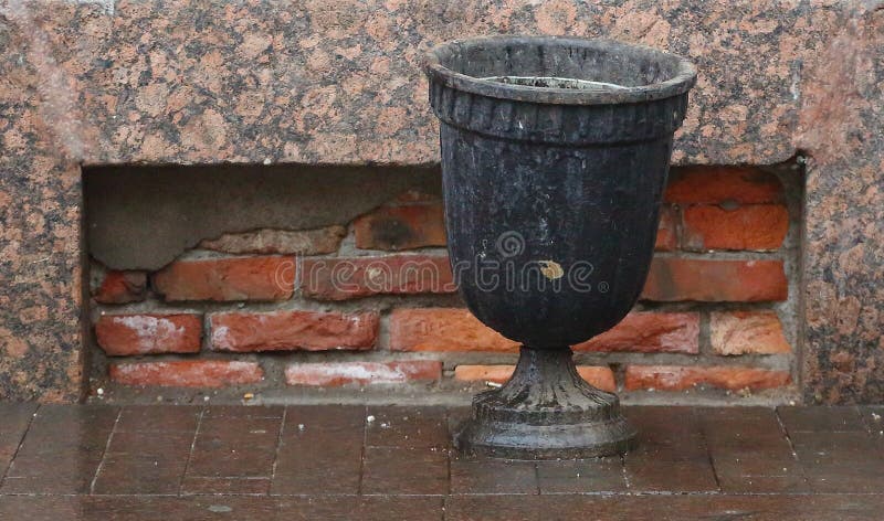 Black Cast-iron Trash Can by a Brick-lined Basement Window Stock Photo ...