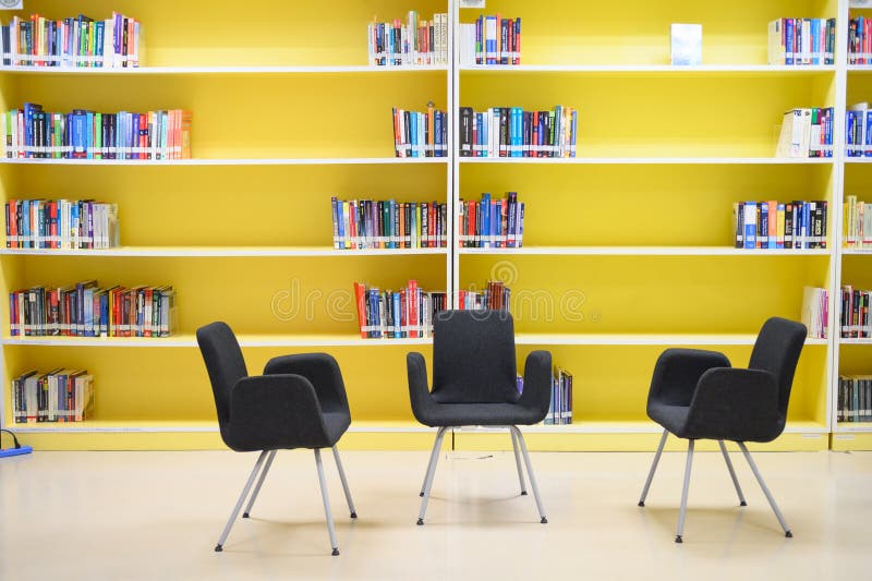 The Black Chair is Located in the Yellow Library Stock Photo - Image of ...