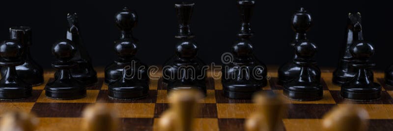 Black Chess Pieces Against White Chess Pieces on a Chessboard Stock ...