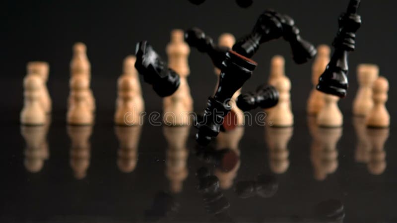 Black Chess Pieces Falling on Black Background with White Pieces Stock ...