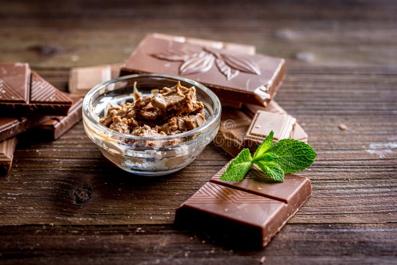Black Chocolate Design with Mint on Wooden Background Stock Photo ...