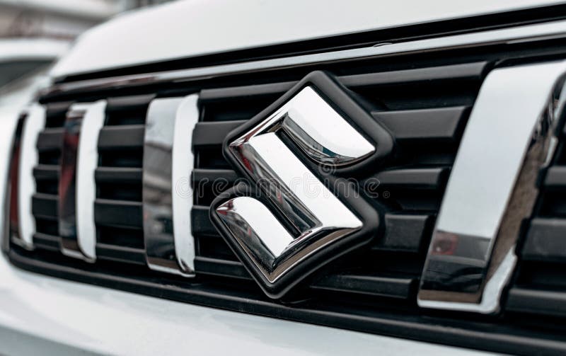 Black and Chrome Trim Around Suzuki Logo on Front of a Silver Car ...