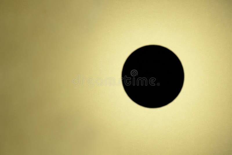 A Black Circle on a Yellow Background is Like an Eclipse. Space for ...