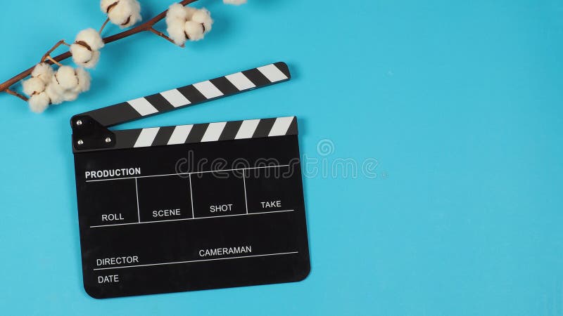 Black Clapper Board and Cotton Flowers on Blue Background Stock Photo ...