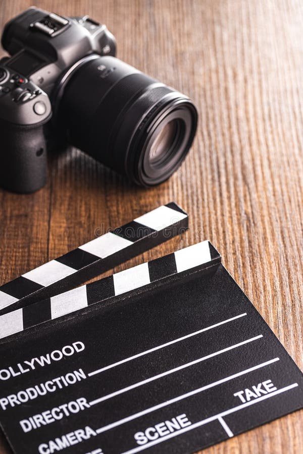 Black Clapper Board and Digital Camera on Wooden Table Stock Photo ...