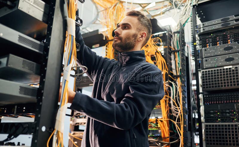 Black Clothes. Young Man is Working with Internet Equipment and Wires ...