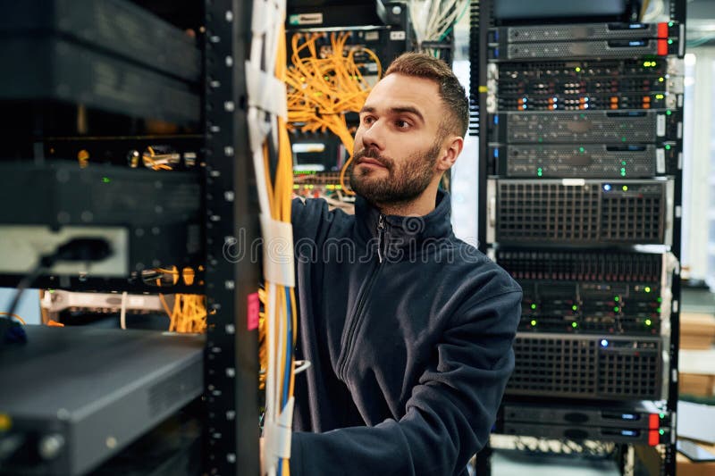 Black Clothes. Young Man is Working with Internet Equipment and Wires ...