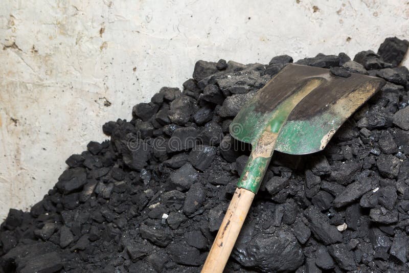 Black Coal and Shovel Lying on a Pile in House Basement Stock Photo ...