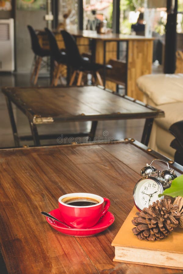 Black Coffee in Red Cup with Book and Clock on Table in Cafe. Stock ...