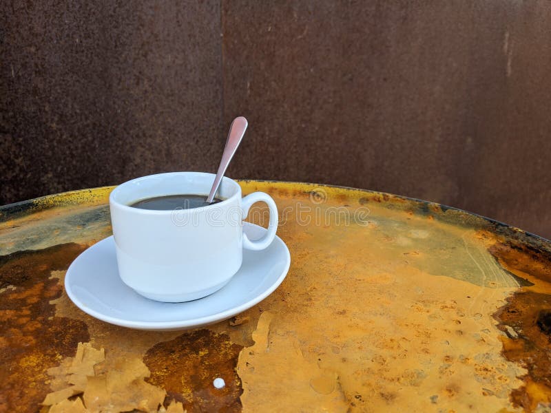 Black Coffee in a White Cup Stands on a Rusty Barrel from Behind a ...