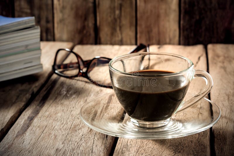 Black Coffee on a Wooden Table while Reading. Stock Photo - Image of ...