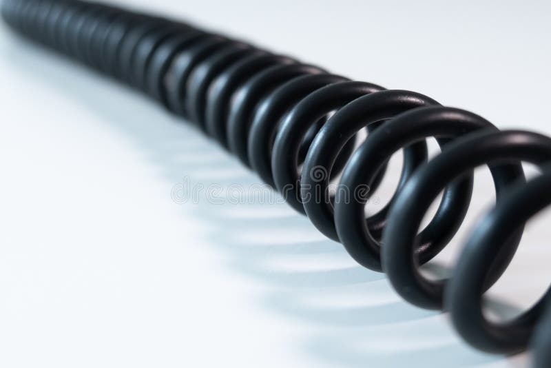 Black Coiled Cable on White Table, Diagonal Right To Left. Close Up ...