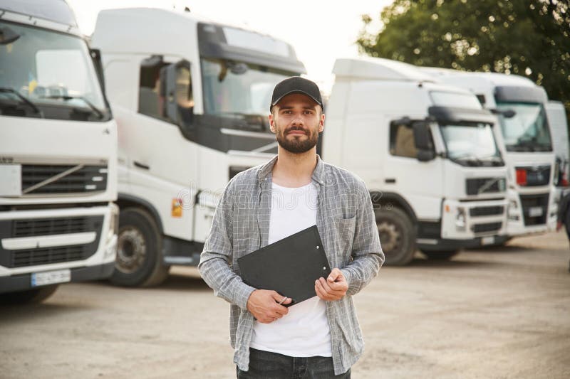 Black Colored Notepad in Hands. Young Truck Driver in Casual Clothes ...