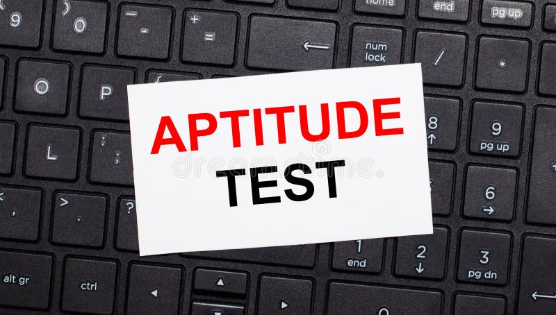 On a Black Computer Keyboard There is a White Card with the Text ...