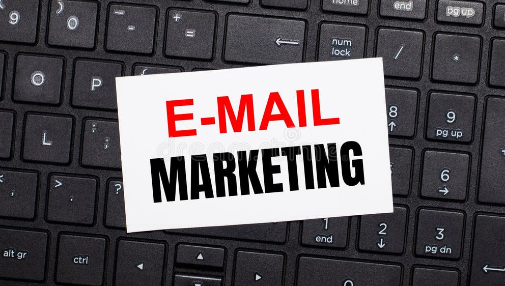 On a Black Computer Keyboard There is a White Card with the Text E-MAIL ...