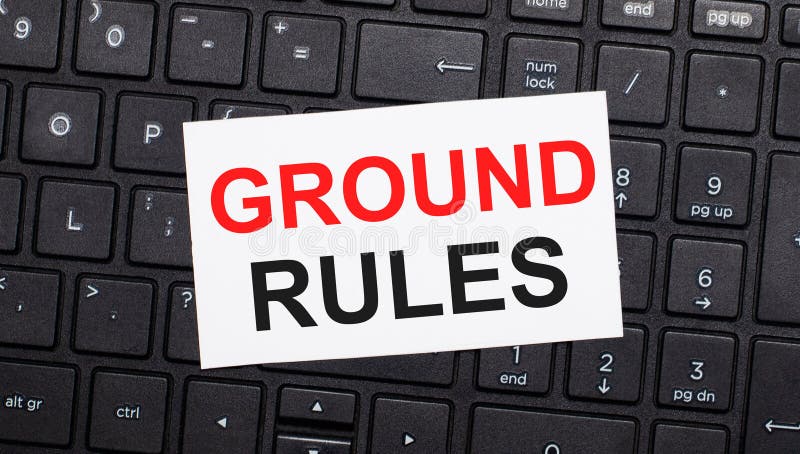 On a Black Computer Keyboard There is a White Card with the Text GROUND ...