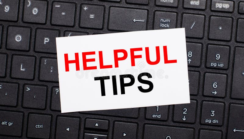 On a Black Computer Keyboard There is a White Card with the Text ...