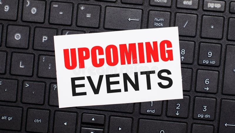 On a Black Computer Keyboard There is a White Card with the Text ...