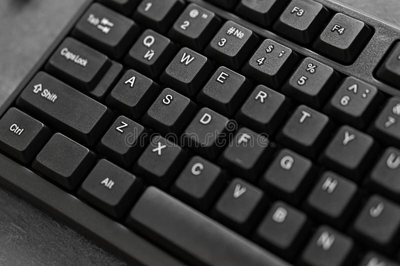 A Black Computer Keyboard with White Sticky Key Designations in English ...