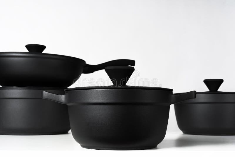 Black Cooking Pots on Grey Background Front View Stock Photo - Image of ...