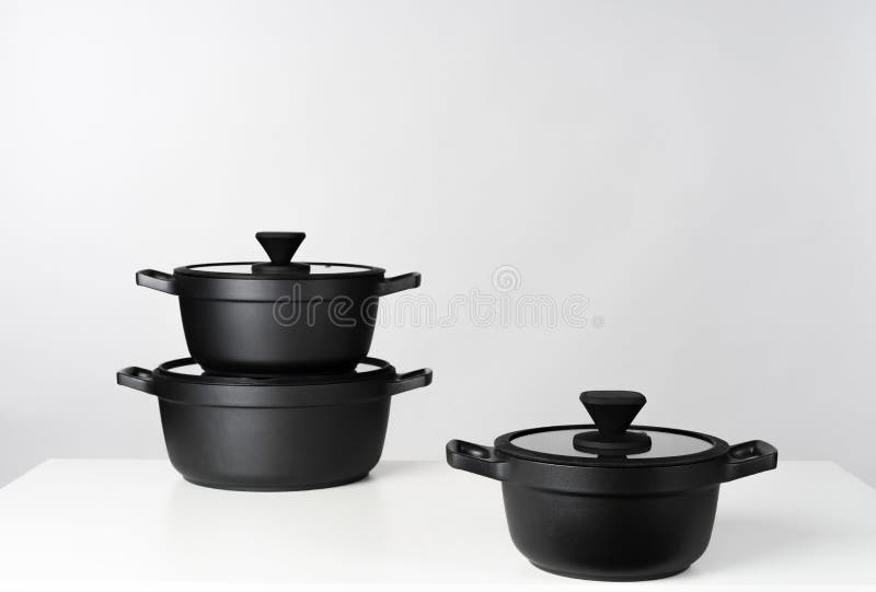 Black Cooking Pots on Grey Background Front View Stock Image - Image of ...