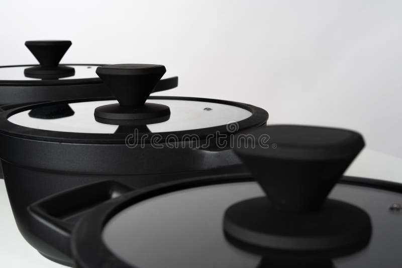 Black Cooking Pots on Grey Background Front View Stock Photo - Image of ...