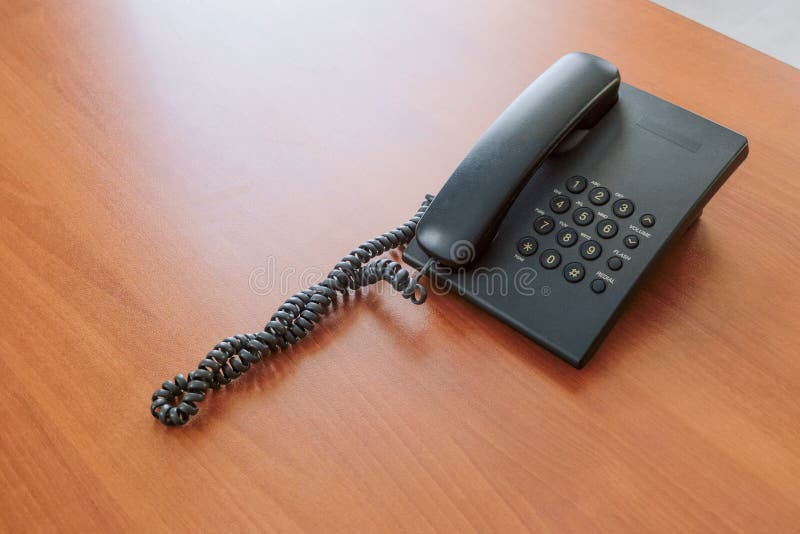 Black Corded Telephone with Buttons on a Brown Office Table Stock Image ...