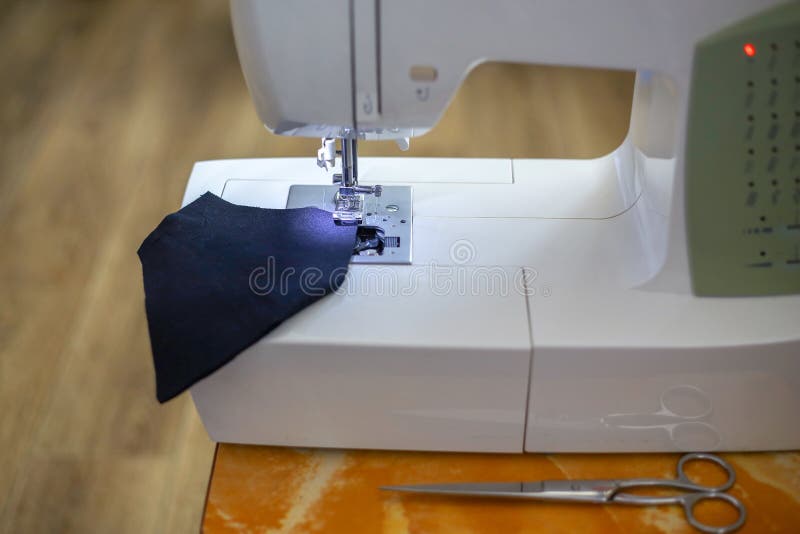 Black Cotton Fabric on a Sewing Machine. Sewing a Face Mask Stock Image ...