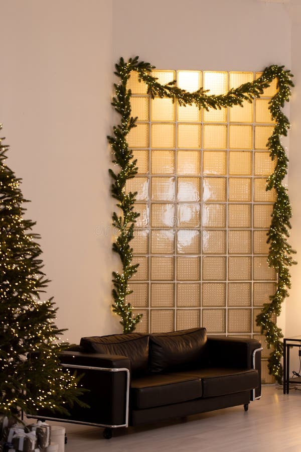 A Black Couch is in Front of a Christmas Tree and a Partition Made of ...